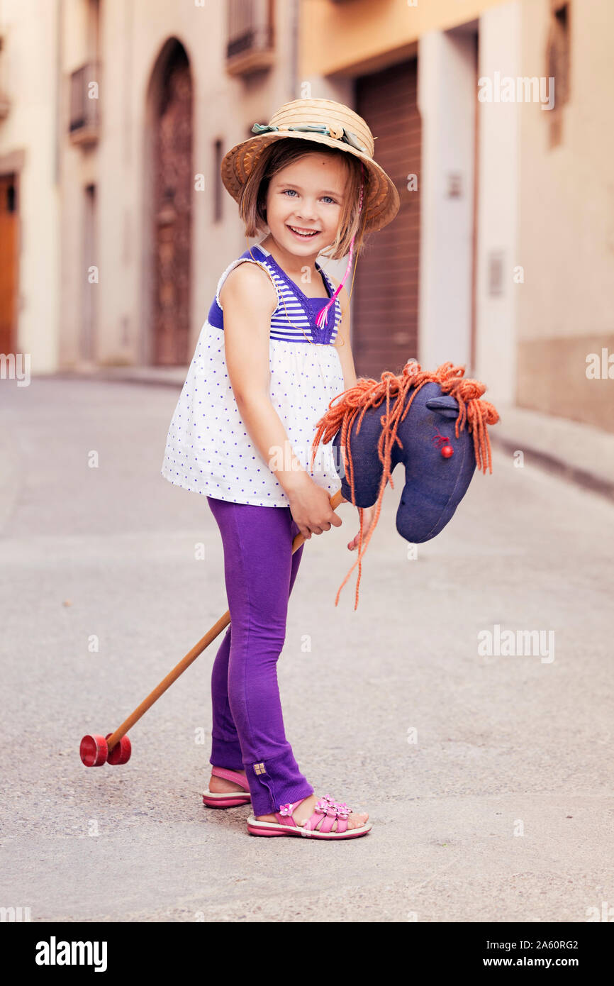 Portrait of little girl with hobby horse Stock Photo - Alamy
