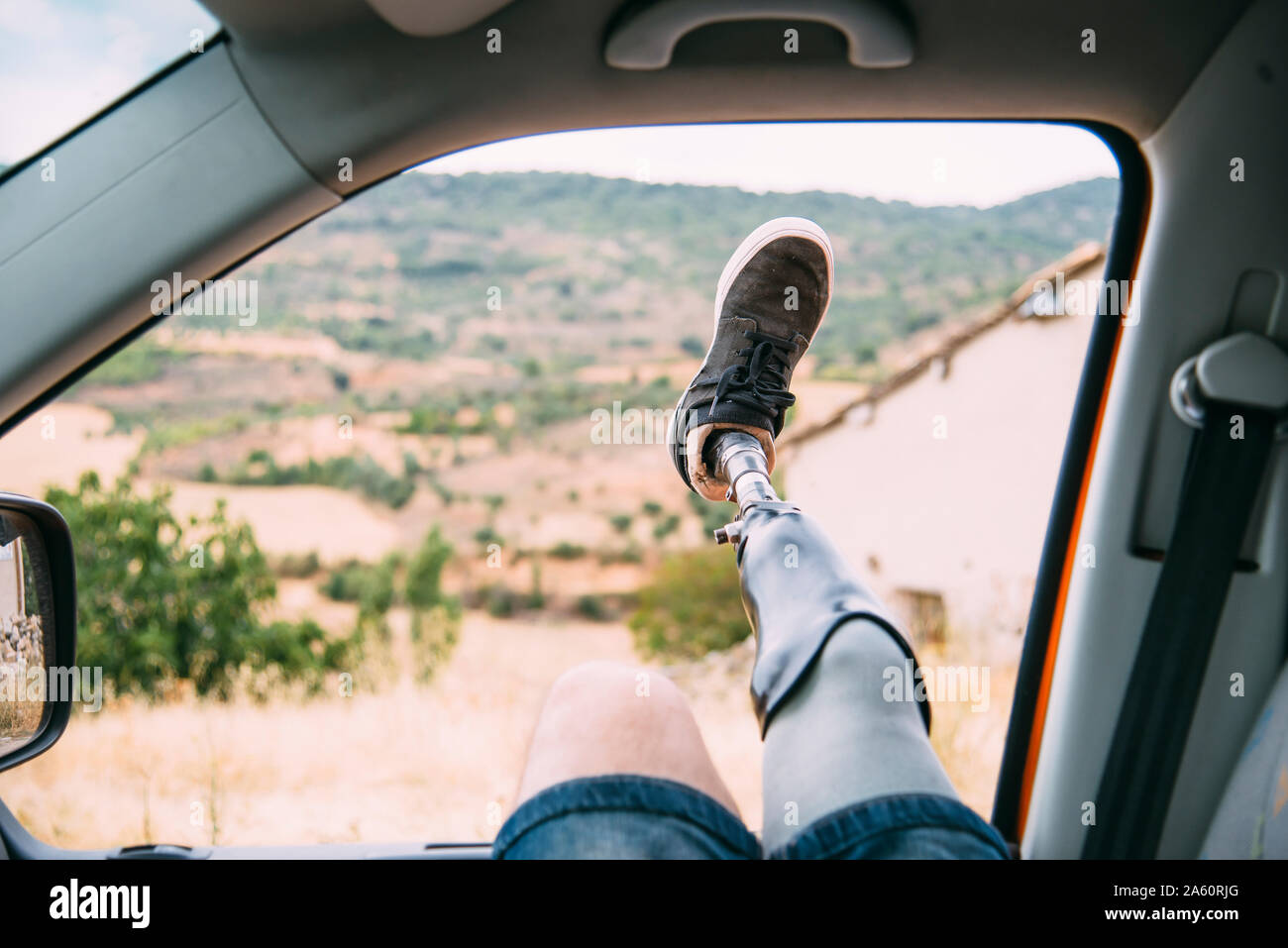 Legs of prosthetic young man dangling out of camper van window Stock ...