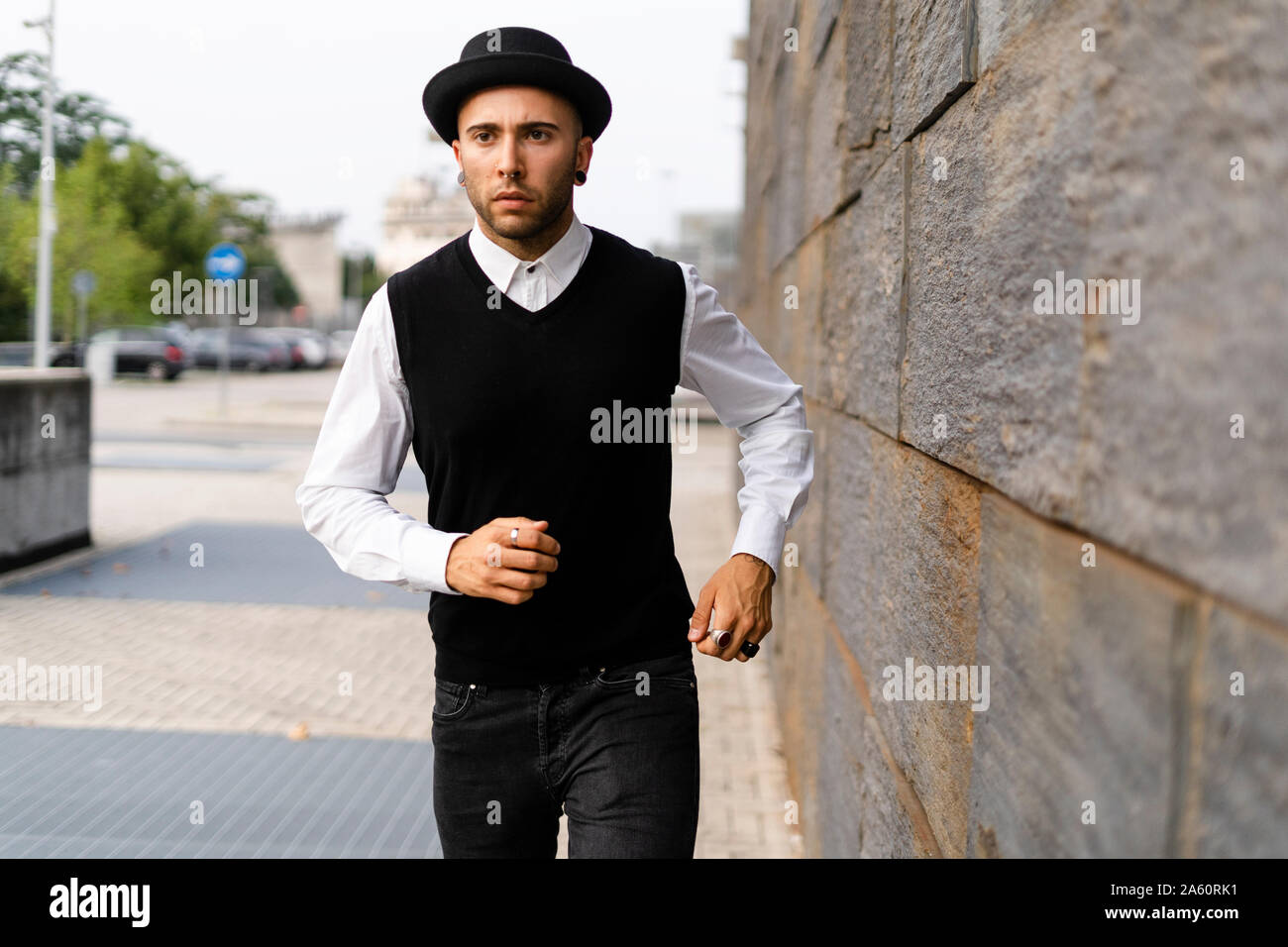 Portrait of running young man dressed in black and white Stock Photo ...
