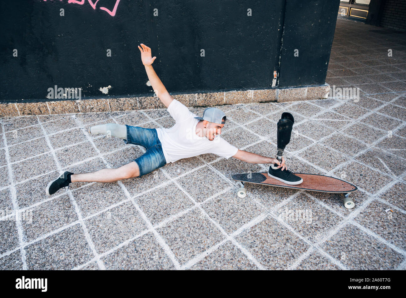 Amputated young man having fun with leg prosthesis and skateboard Stock ...