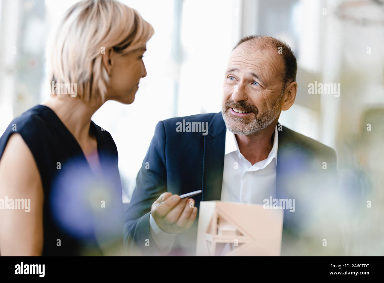 Architect explaining model to customer Stock Photo - Alamy