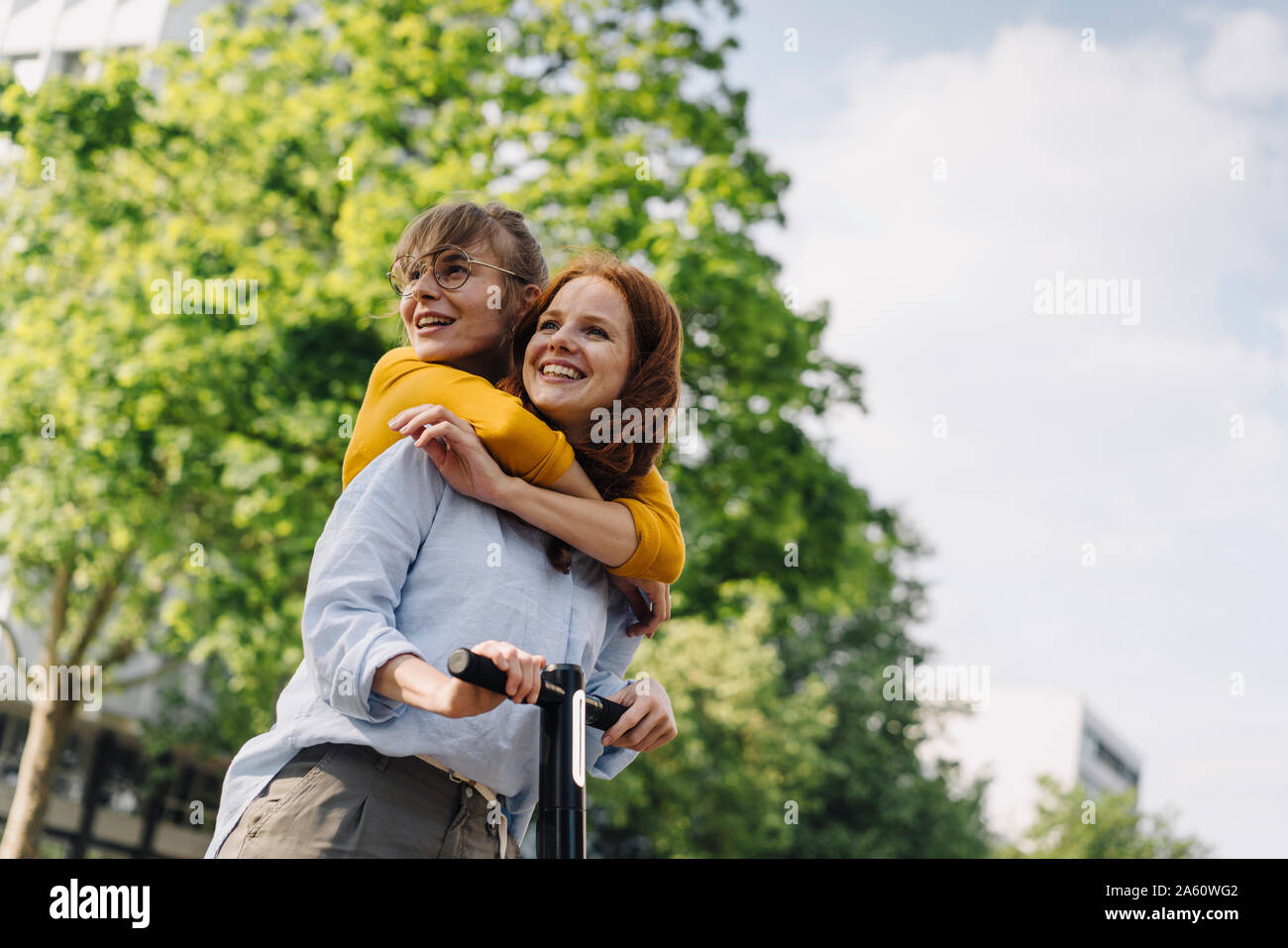 Joyful young woman hugging hi-res stock photography and images - Alamy