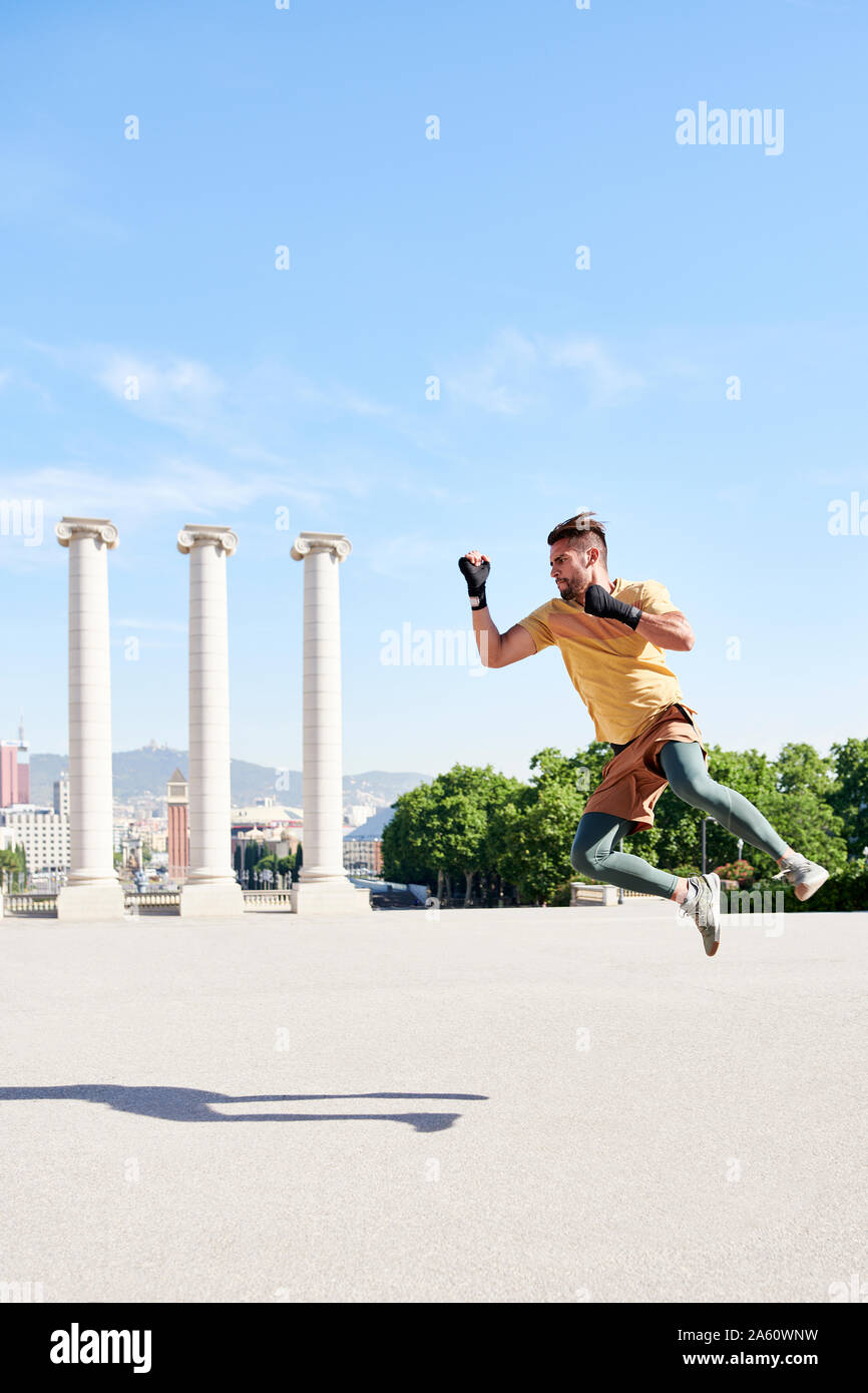 Man doing kickboxing exercise outdoors in the city Stock Photo - Alamy