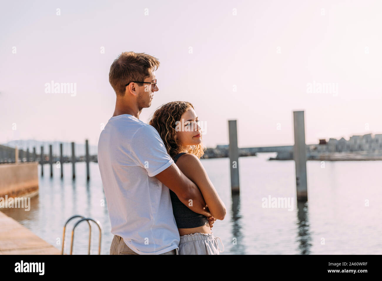 Side view attractive couple hugging hi-res stock photography and images ...