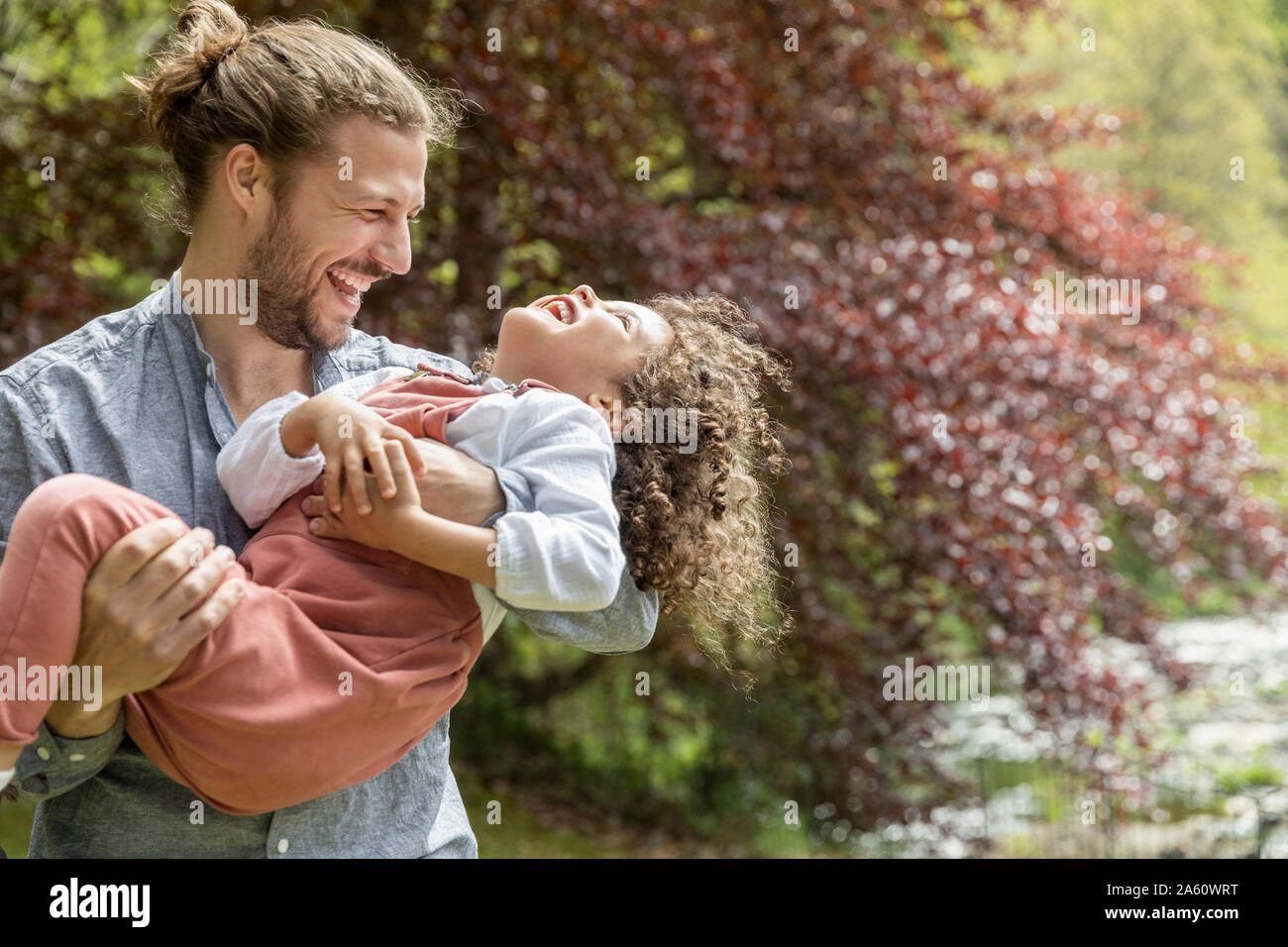 Happy father having fun with son in garden Stock Photo - Alamy