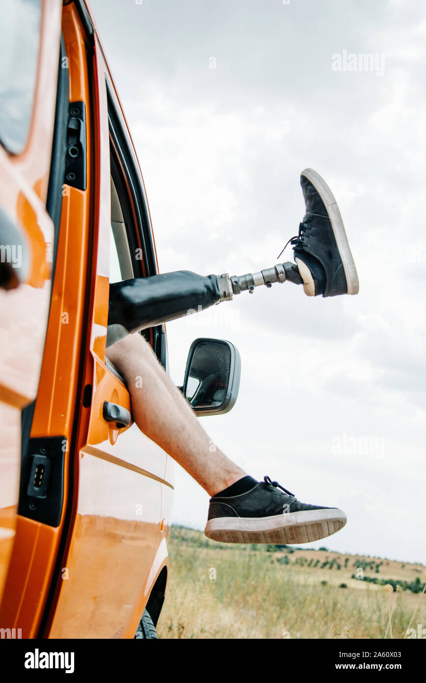 Legs of prosthetic young man dangling out of camper van window Stock ...