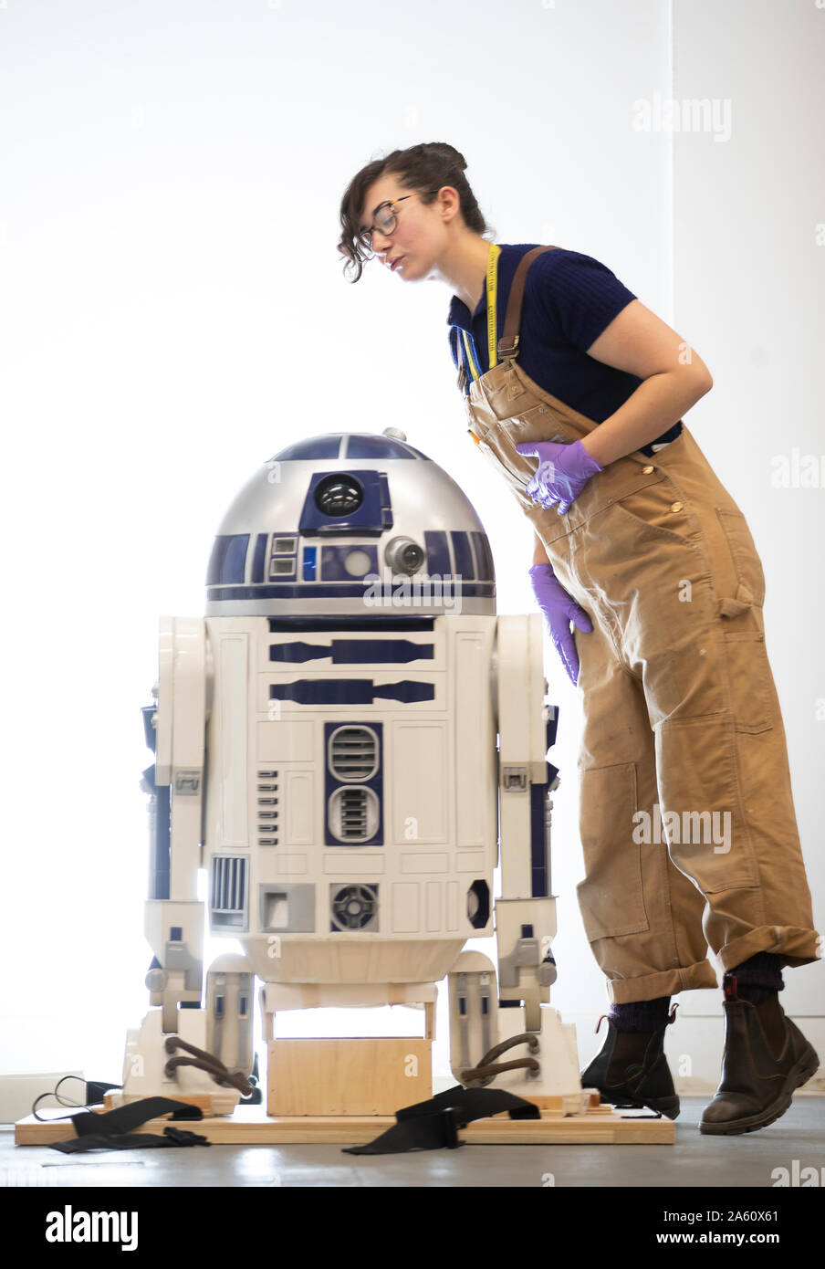 Museum technician Jessie Giovane Staniland checks the original R2-D2 ...