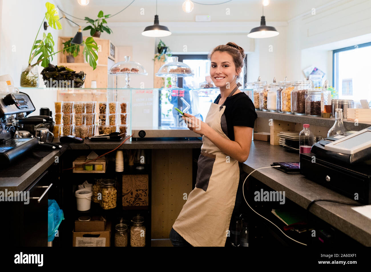 Young woman behind shop counter hi-res stock photography and images - Alamy