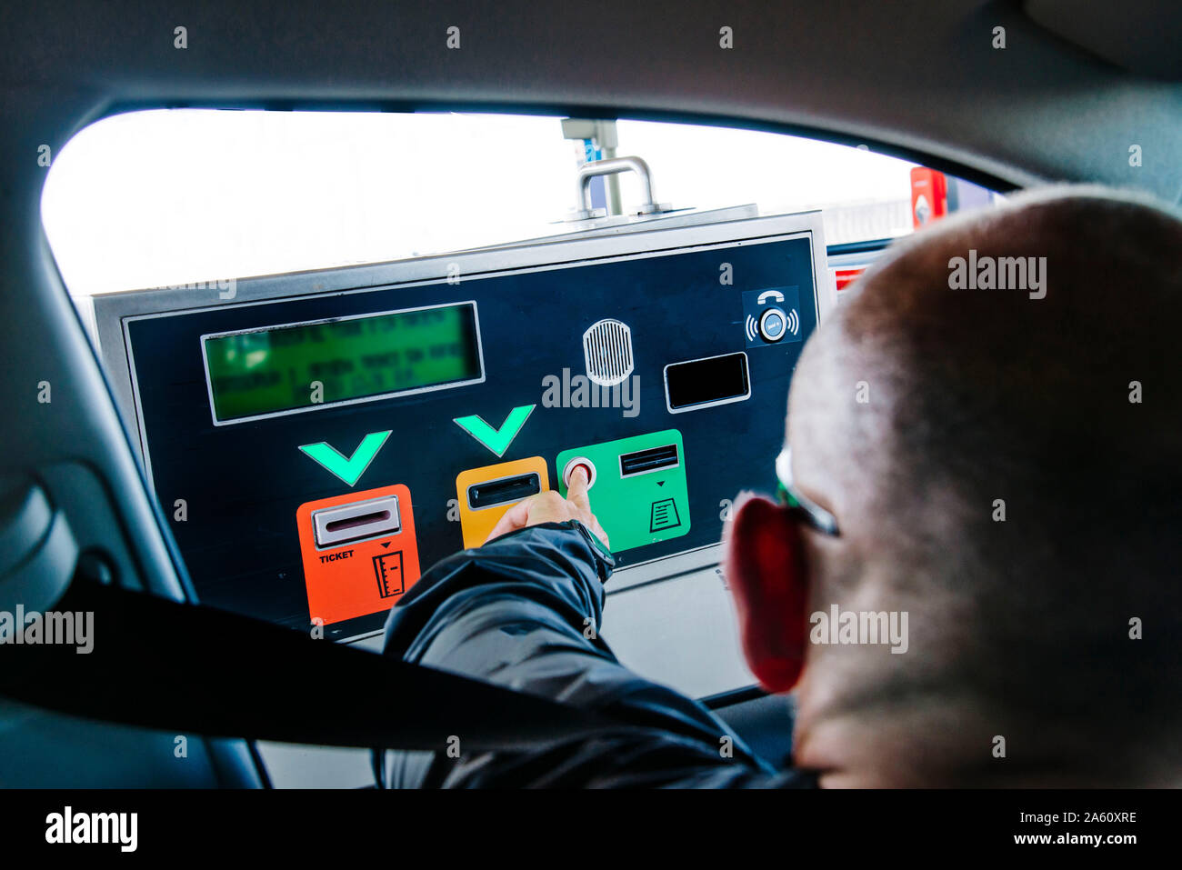 Man paying road toll Stock Photo - Alamy
