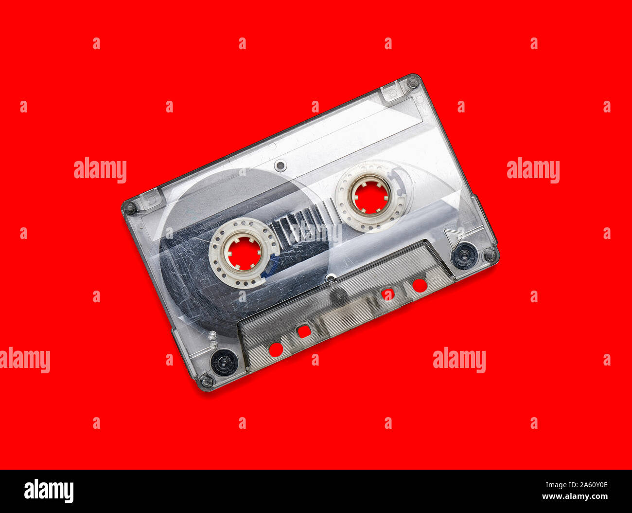 Old audio casette with vintage look, recto side on red background ...