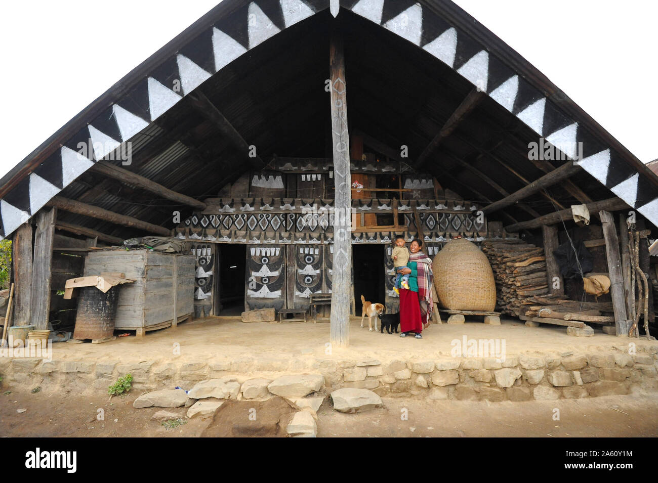 Mother and her child outside their traditionally decorated Naga home ...