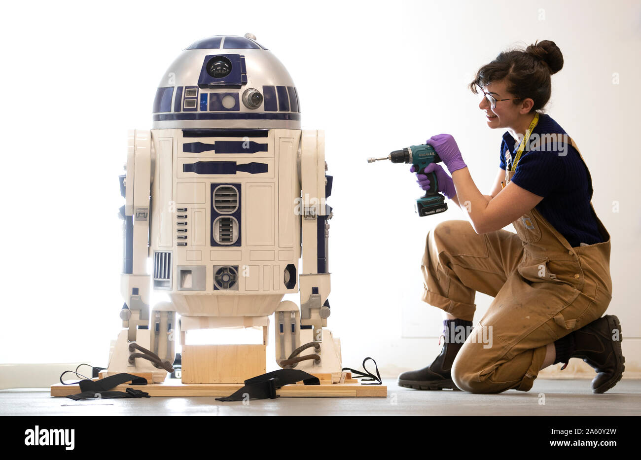 Museum technician Jessie Giovane Staniland checks the original R2-D2 ...