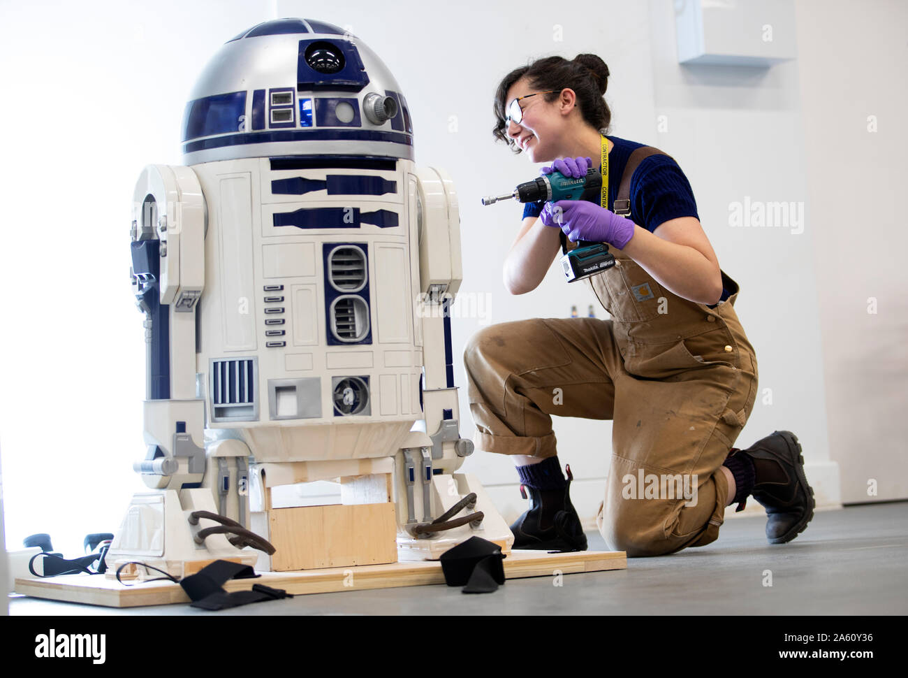 Museum technician Jessie Giovane Staniland checks the original R2-D2 ...