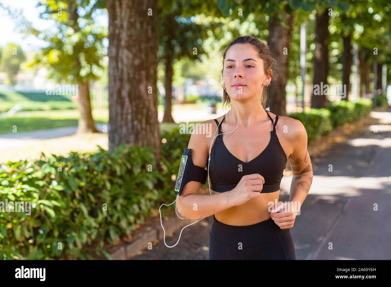 Young woman running on road hi-res stock photography and images - Alamy