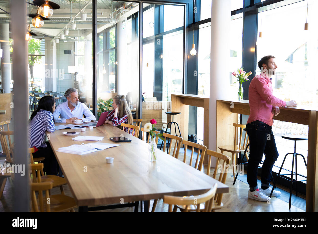 Casual business people having a meeting in a cafe Stock Photo - Alamy