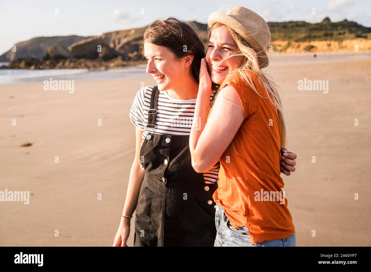 Two girlfriends having fun, walking on the beach Stock Photo - Alamy
