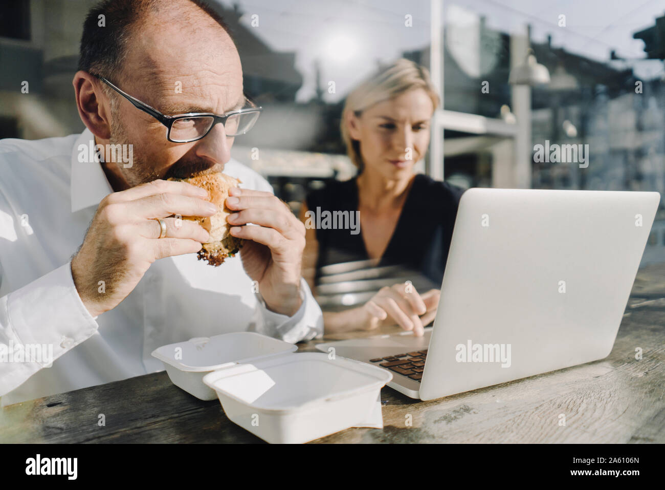 Businessman eating hamburger in coffee shop hi-res stock photography ...