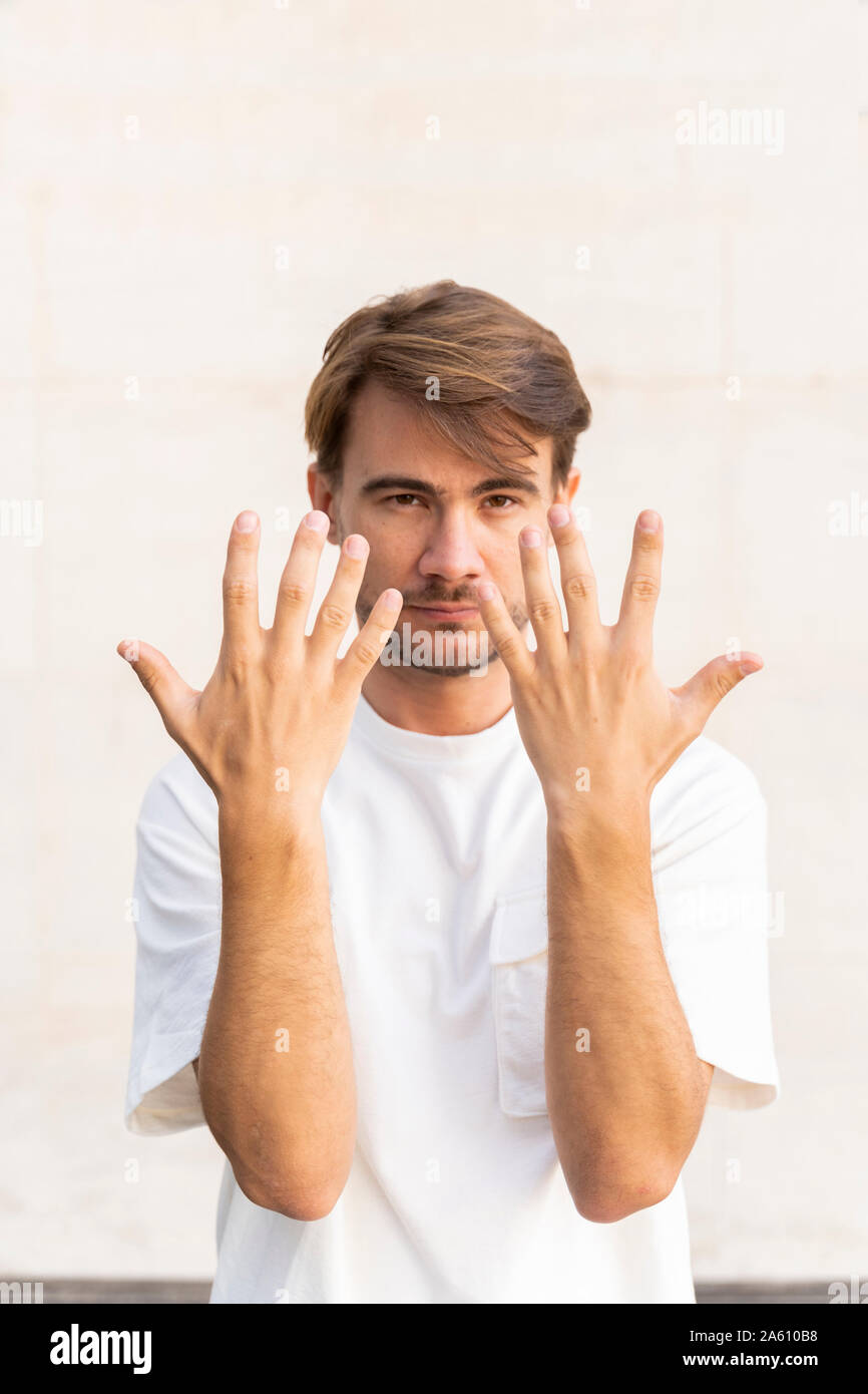 Portrait of man raising hands Stock Photo - Alamy