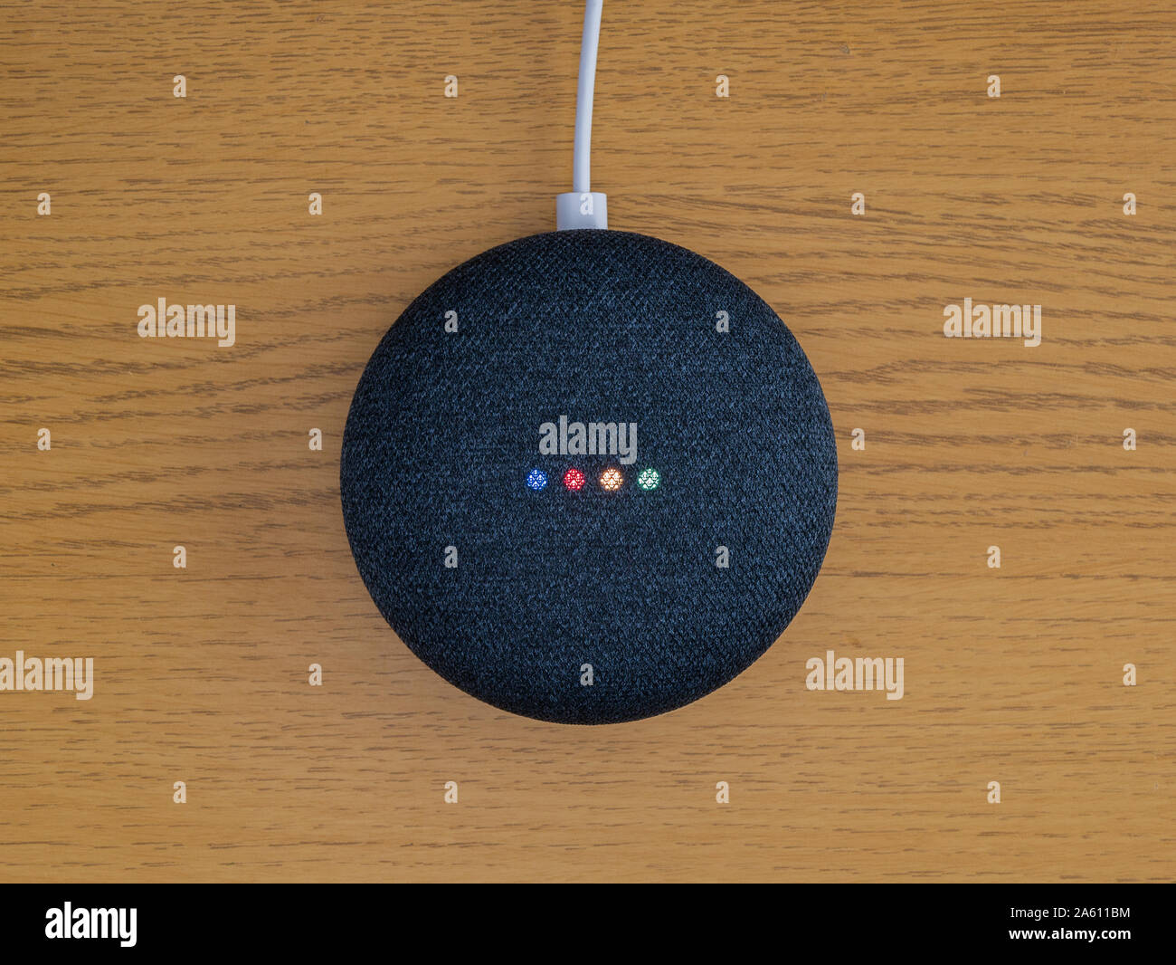 smart home voice activated speaker on wooden desk table from above ...