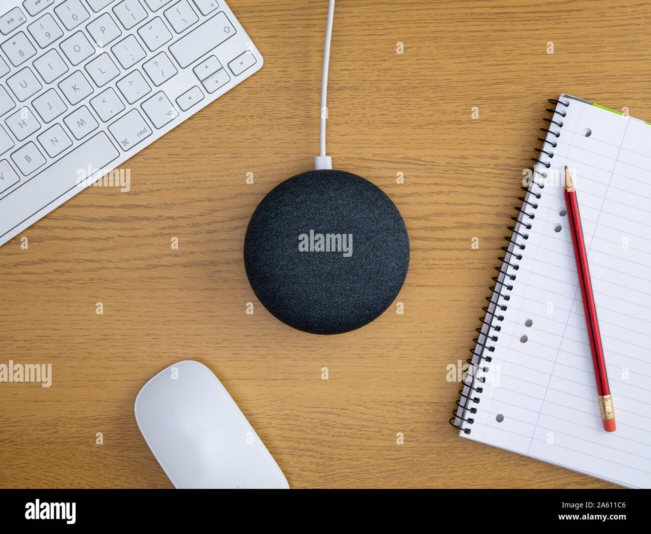 smart home voice activated speaker on wooden desk table with mouse ...