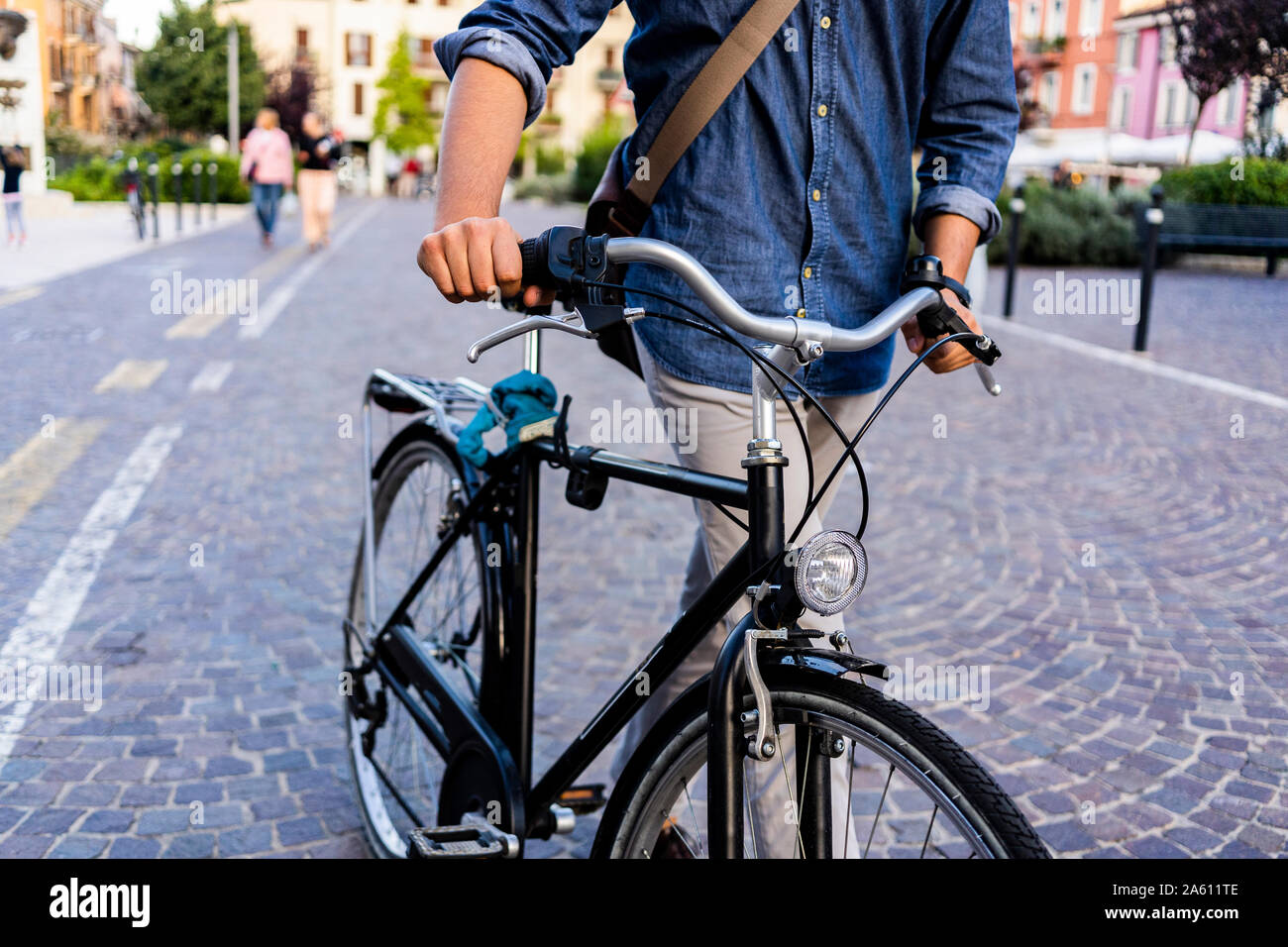 Man pushing a bicycle in the city Stock Photo - Alamy