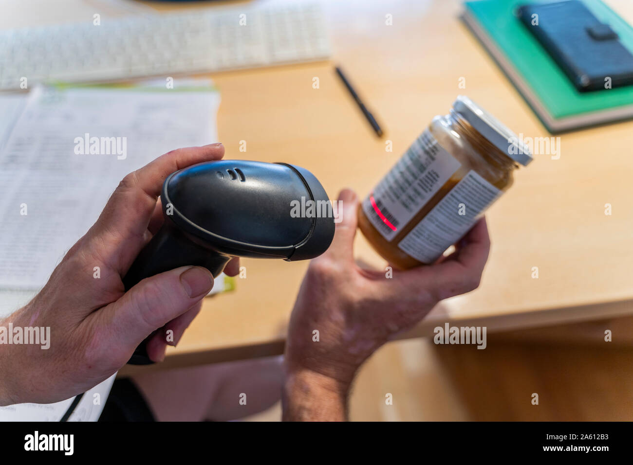 Man scanning label on a screwtop glass Stock Photo - Alamy