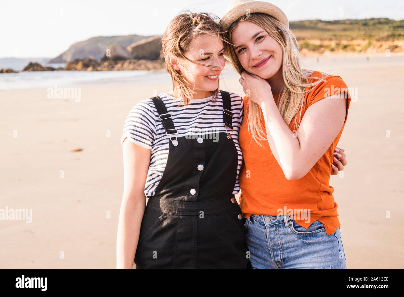 Two girlfriends having fun, walking on the beach Stock Photo - Alamy