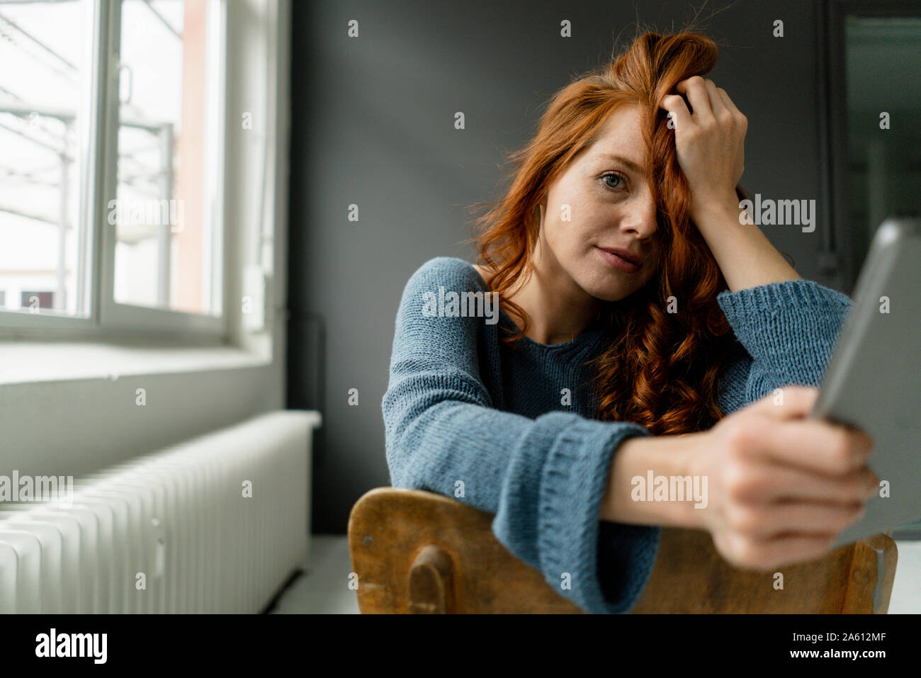 Leaning back in wooden chair hi-res stock photography and images - Alamy