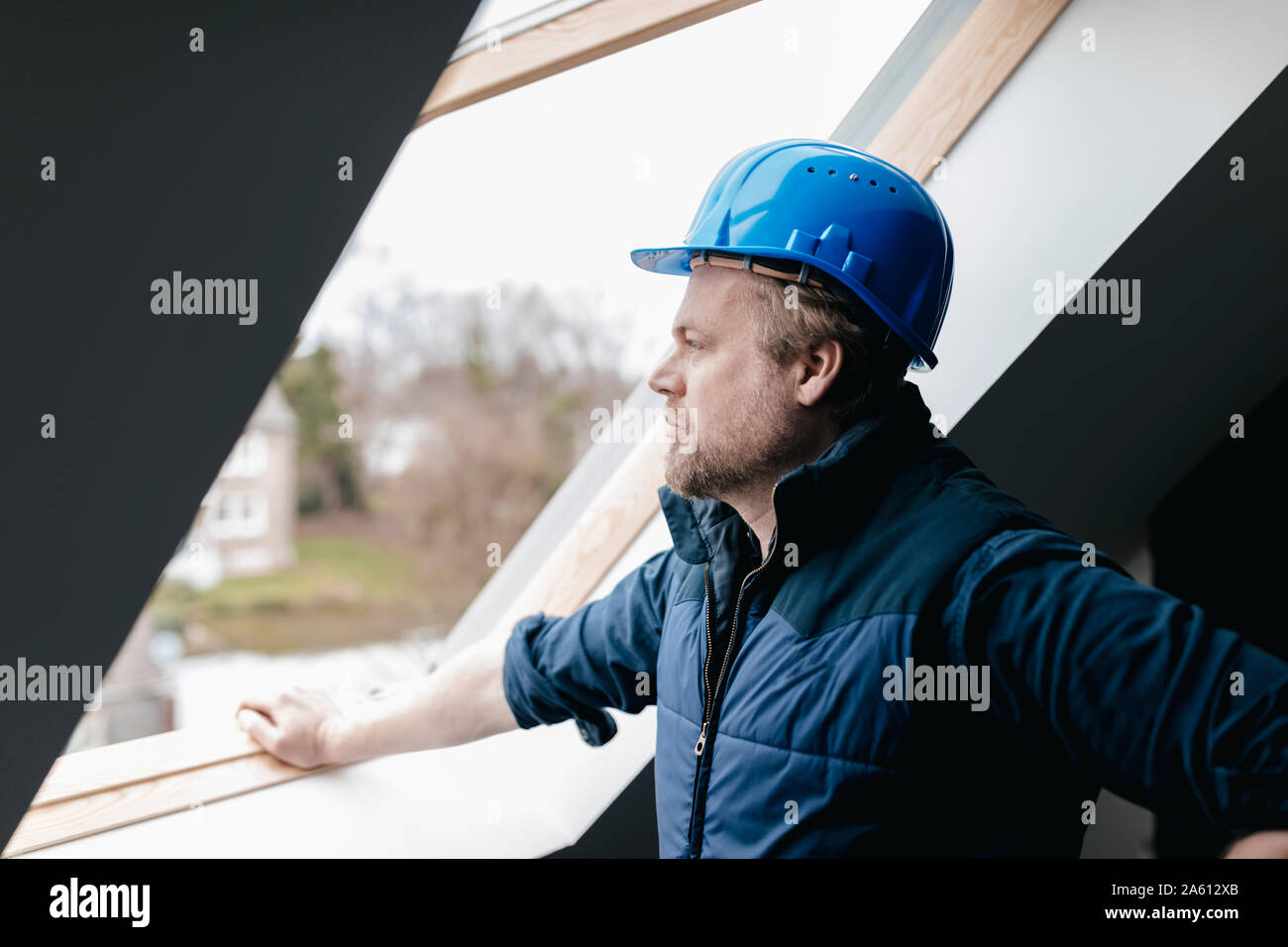 Architect looking out of window on a construction site Stock Photo - Alamy