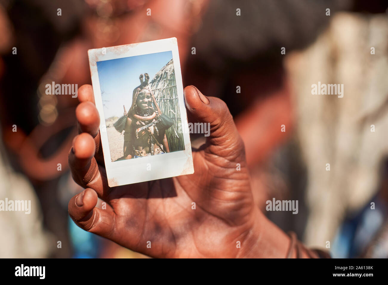Mudimba tribe woman showing a picture of herself, Onocua, Angola Stock ...