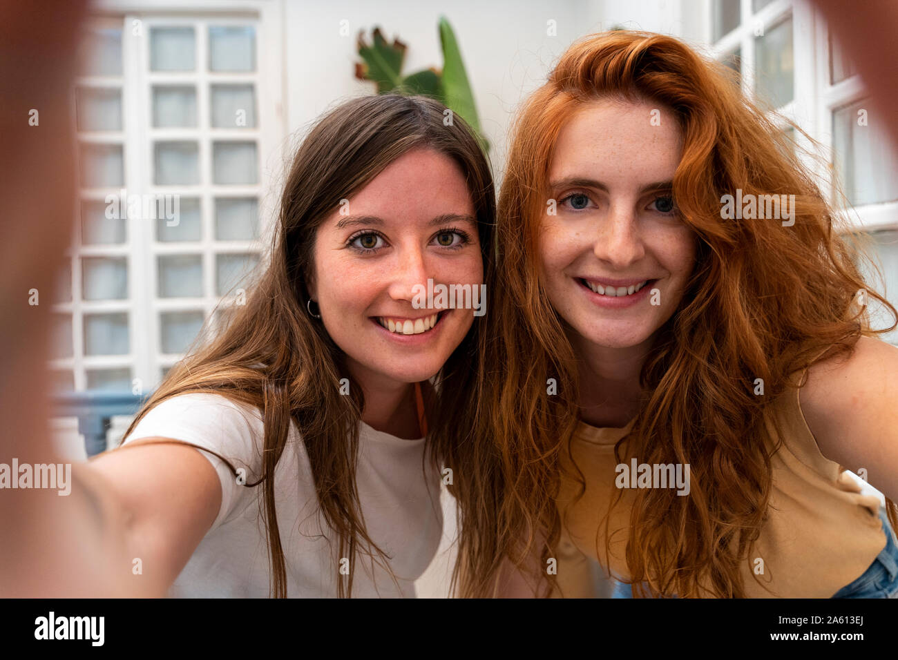 Female friends posing together taking hi-res stock photography and ...
