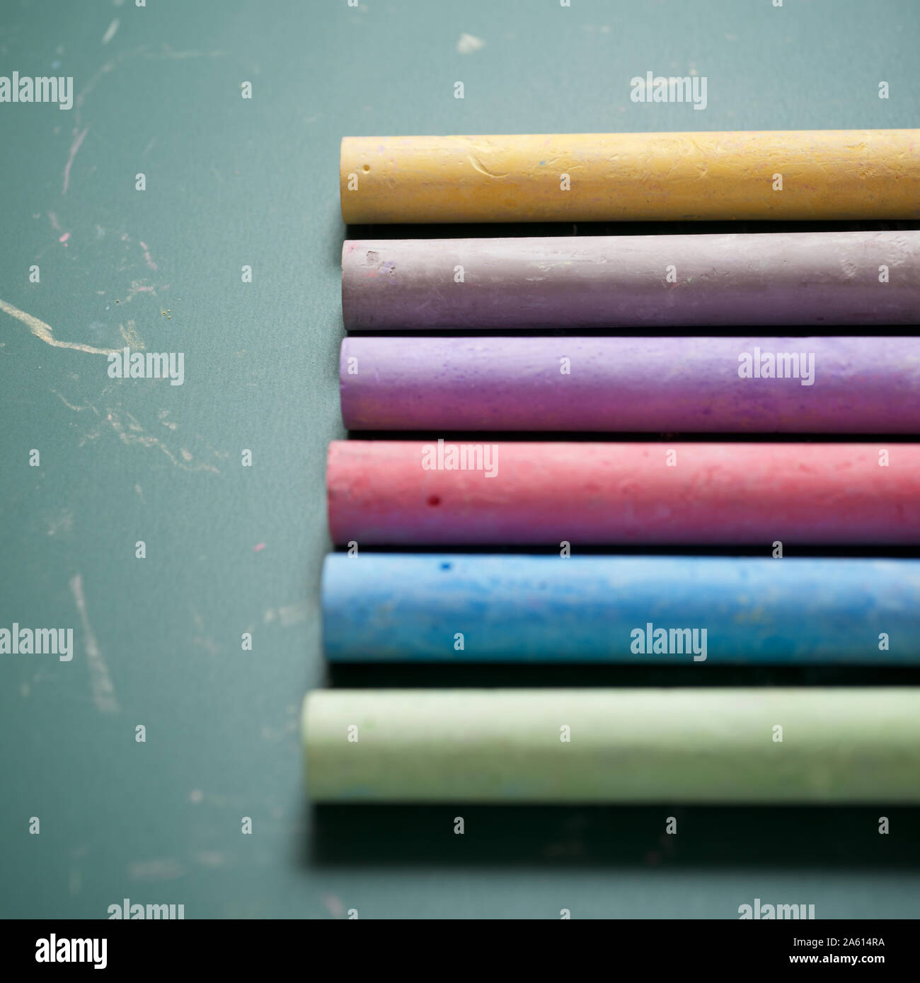 View of a group of chalks and a green blackboard Stock Photo - Alamy