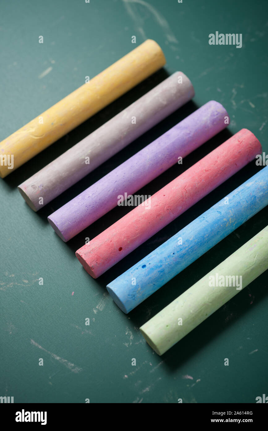 View of a group of chalks and a green blackboard Stock Photo - Alamy