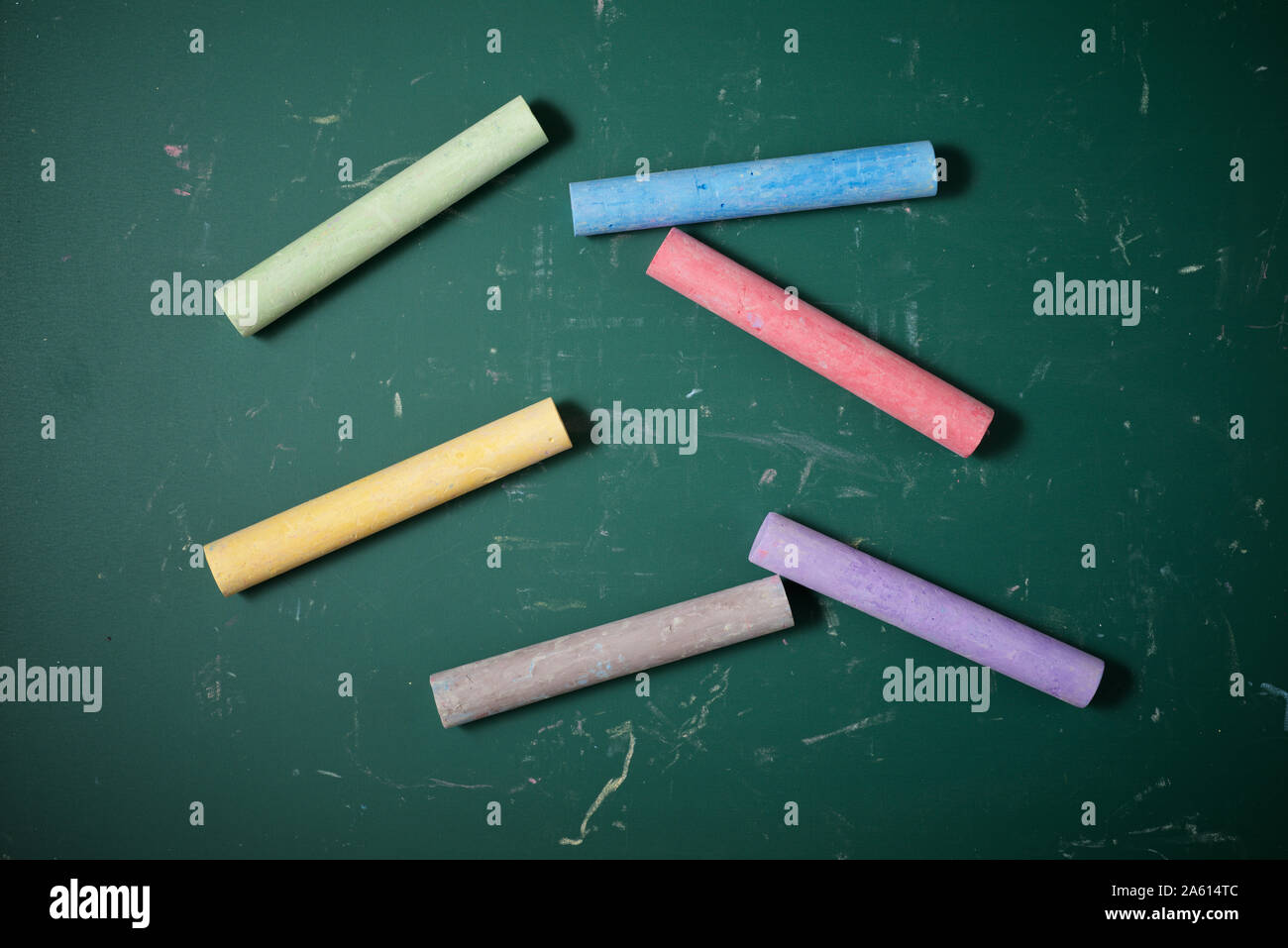 View of a group of chalks and a green blackboard Stock Photo - Alamy