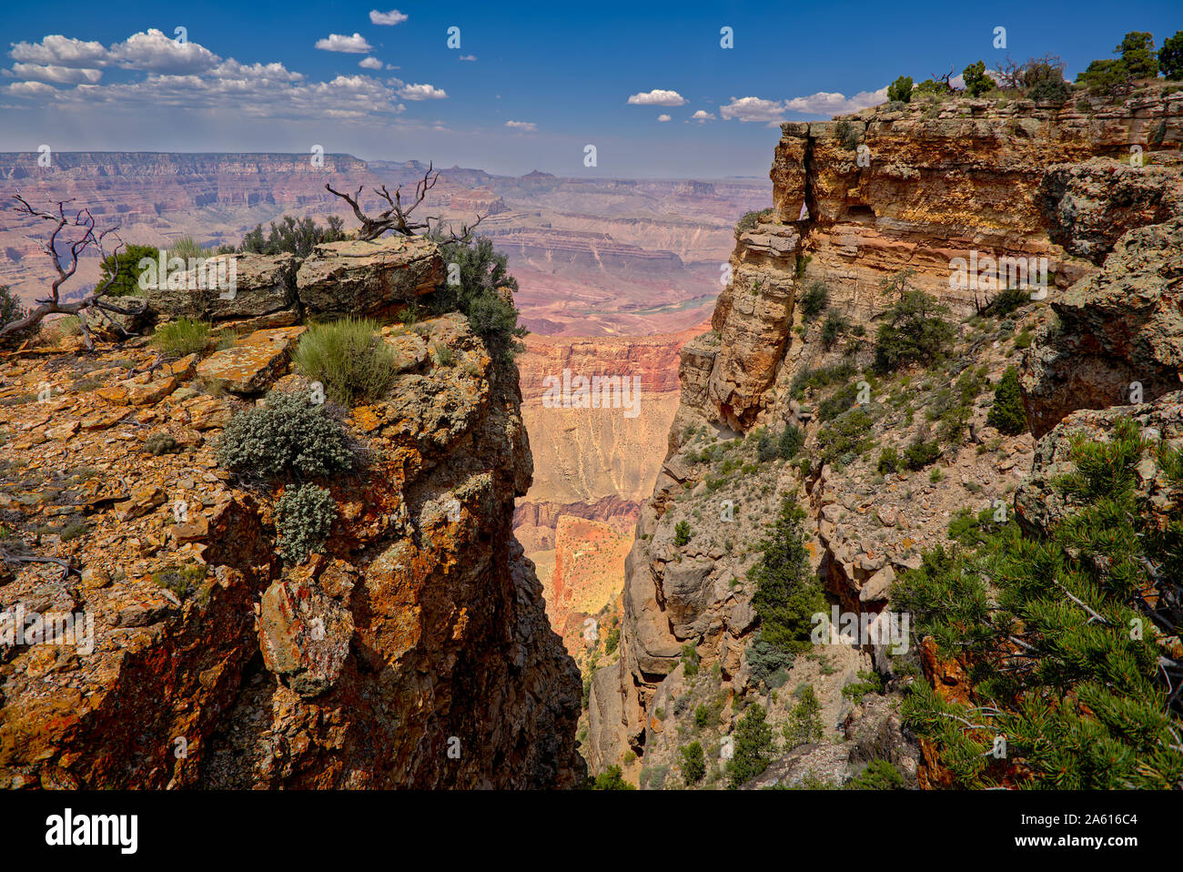 Grand Canyon view between two cliffs with a rock window on the right ...