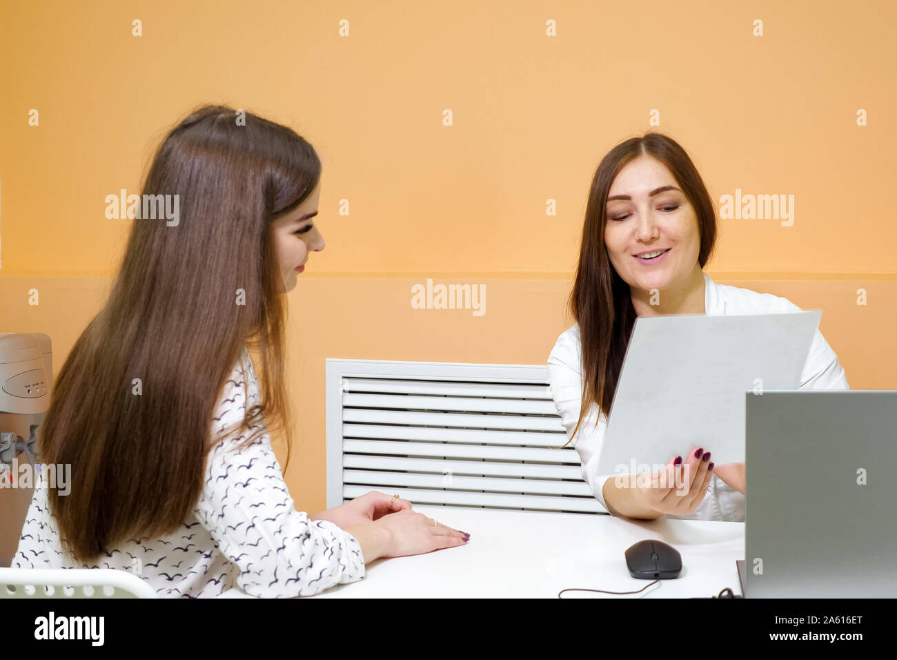 professional girl receptionist holds form paper sheet and talks to long ...