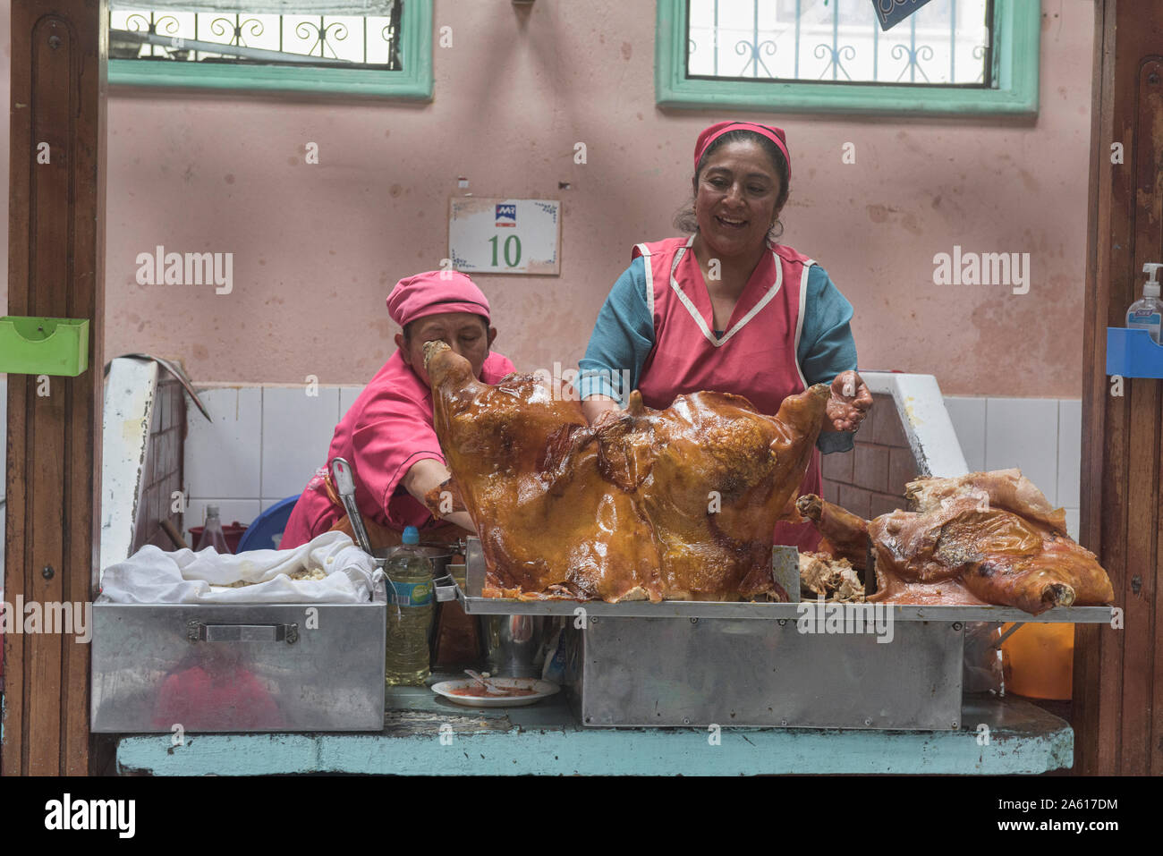 "Hornado" roast pork sellers in La Merced Market, Riobamba, Ecuador ...