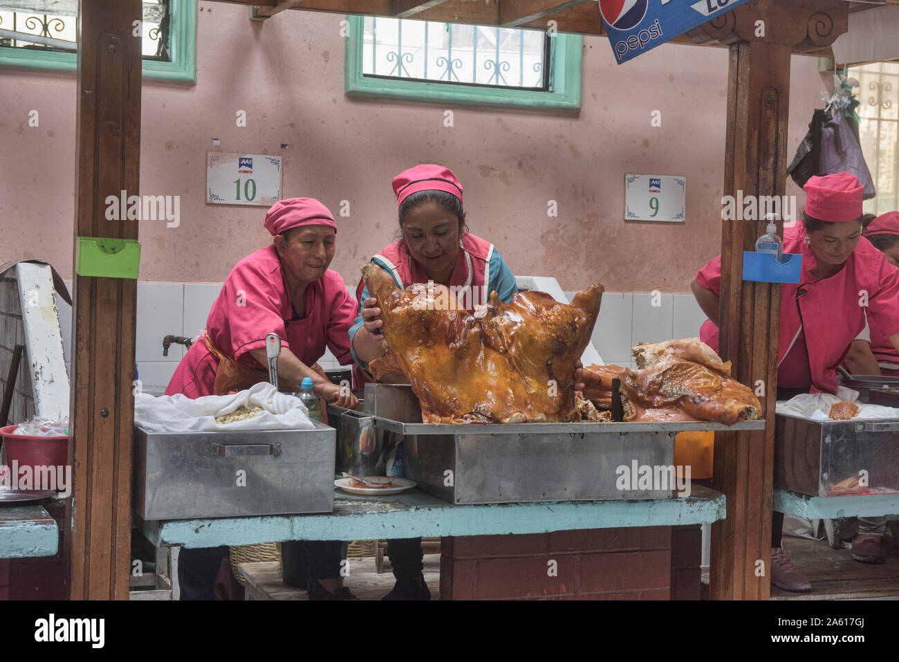 "Hornado" roast pork sellers in La Merced Market, Riobamba, Ecuador ...