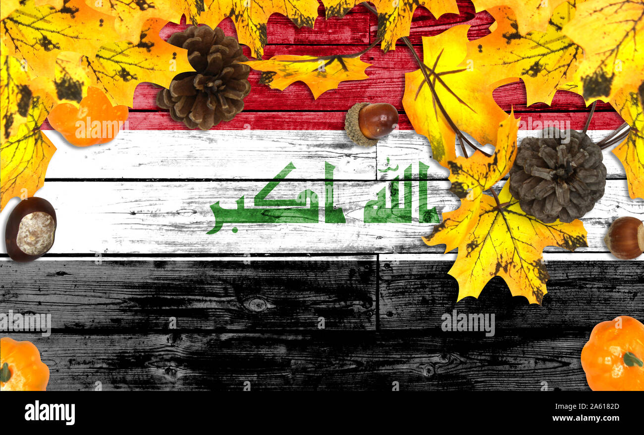 Iraq flag on autumn wooden background with leaves and good place for ...