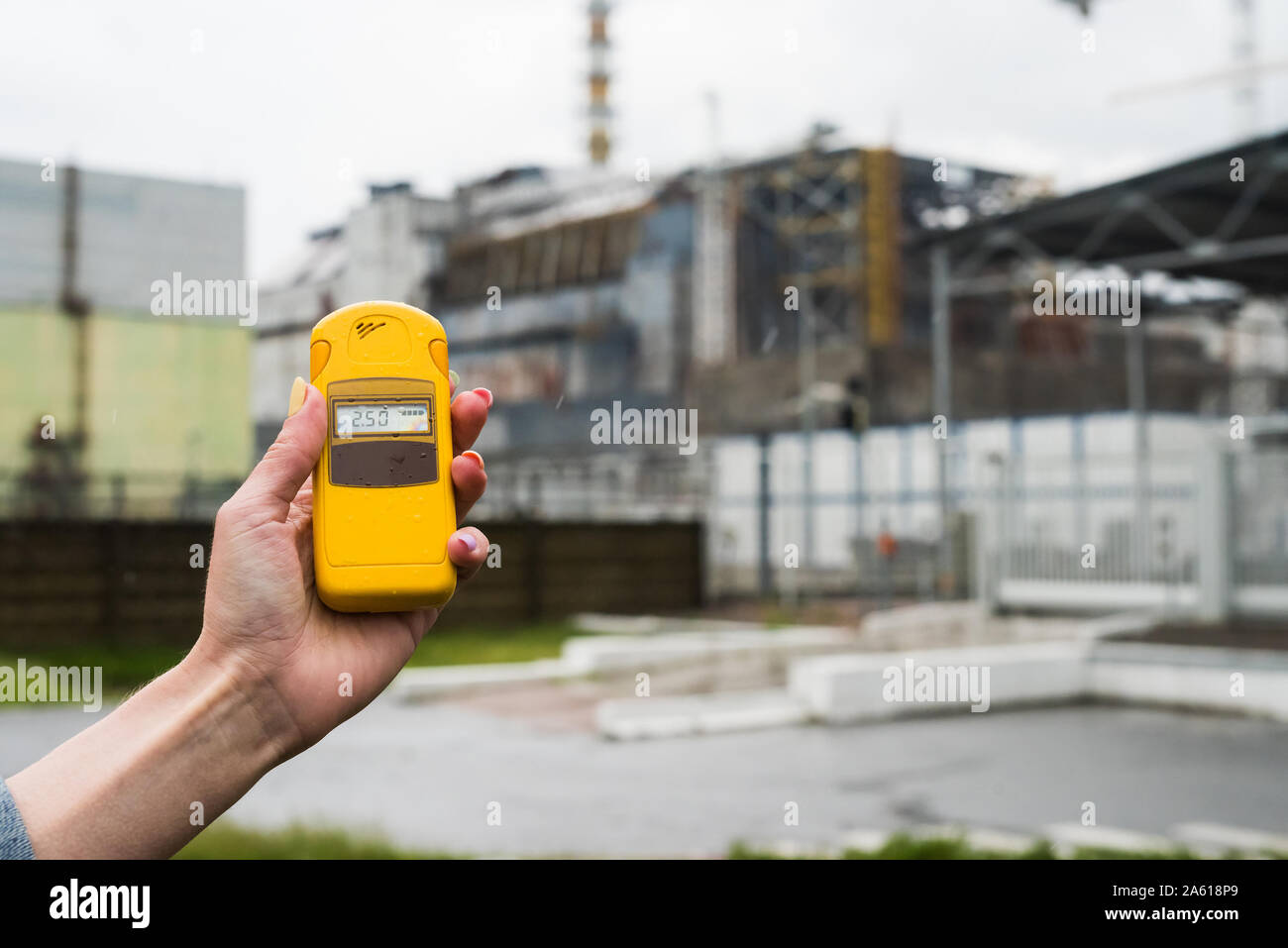 radiometer in hand with fourth Chernobyl reactor on the background ...