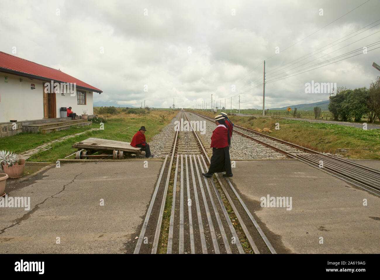 Indigenous highlanders waiting for a train, Urbina, Ecuador Stock Photo ...