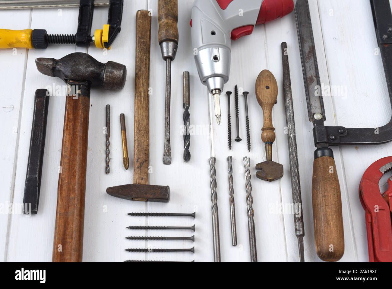 different carpenters and mechanics tools on a white wooden table Stock ...