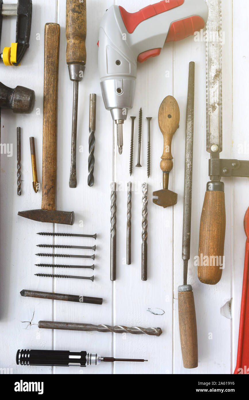 different carpenters and mechanics tools on a white wooden table Stock ...