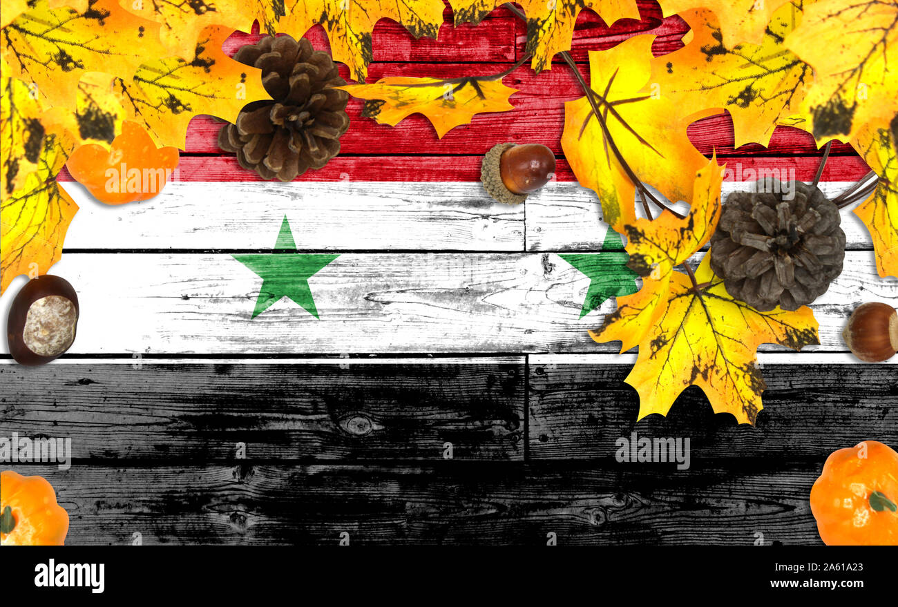 Syria flag on autumn wooden background with leaves and good place for ...