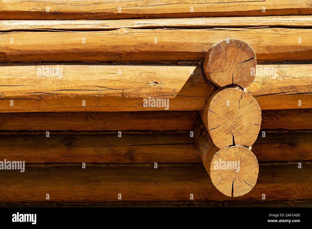 A fragment of a wooden log house made of logs, buildings. Front view ...