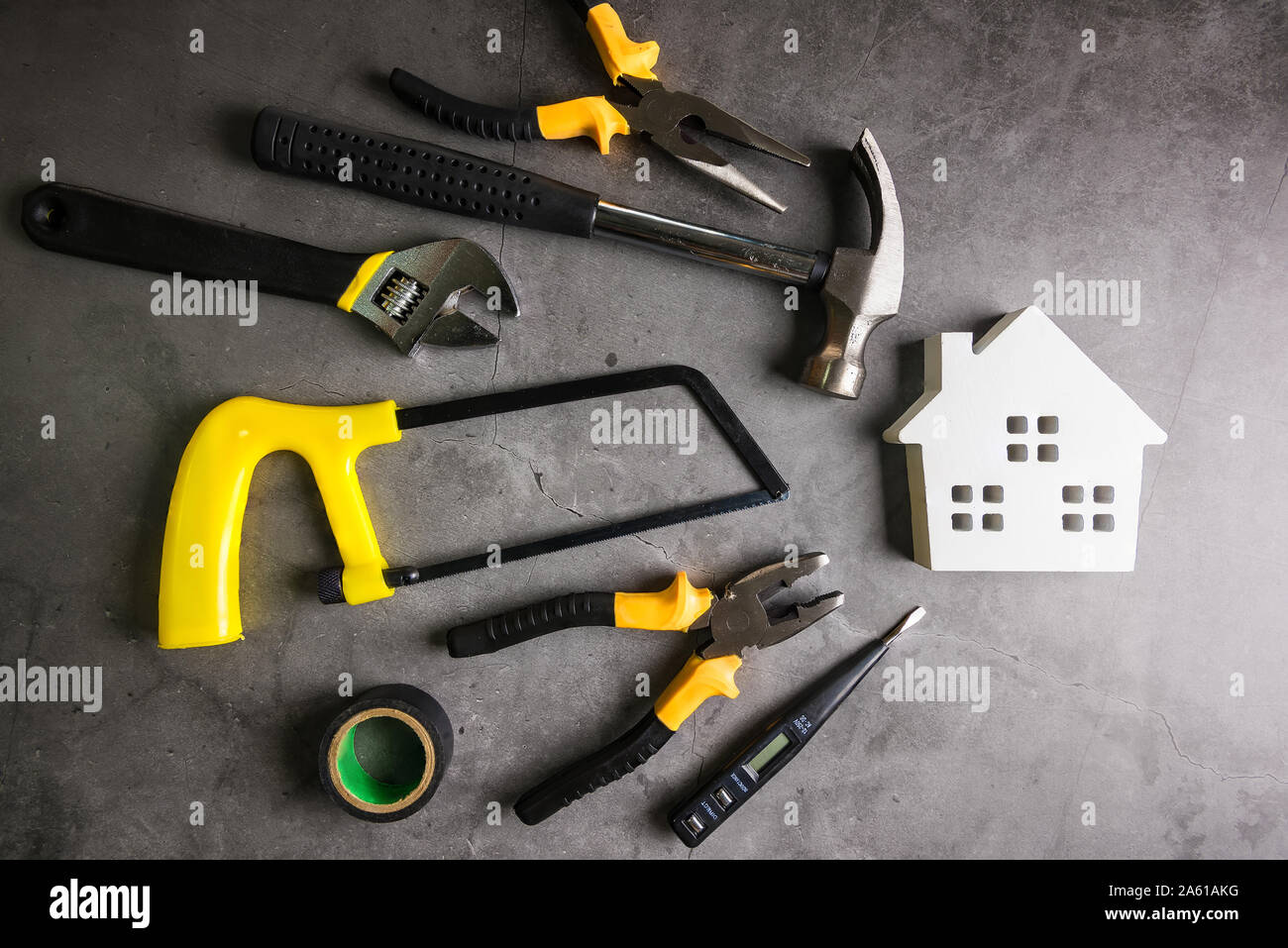 Wooden house and construction tools on stone pattern background with ...