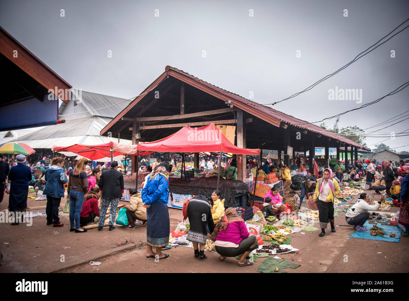A bustling morning at the traditional market in Muang Sing, where ...