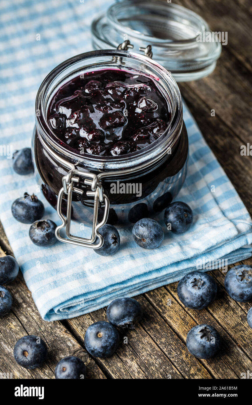 Sweet blueberry jam and blueberries on old wooden table Stock Photo - Alamy