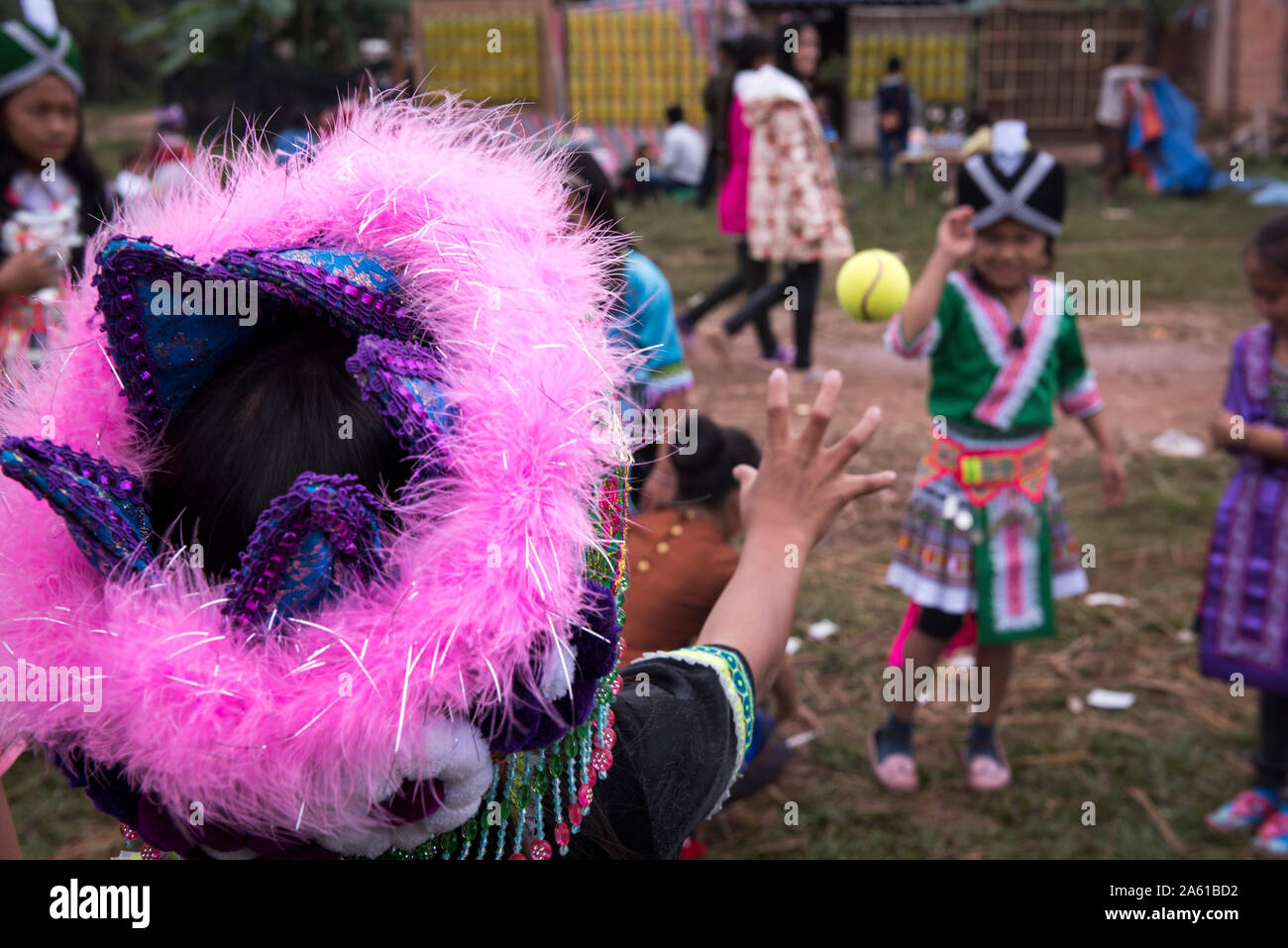 Children enjoy the traditional ball-toss game at the Hmong New Year ...