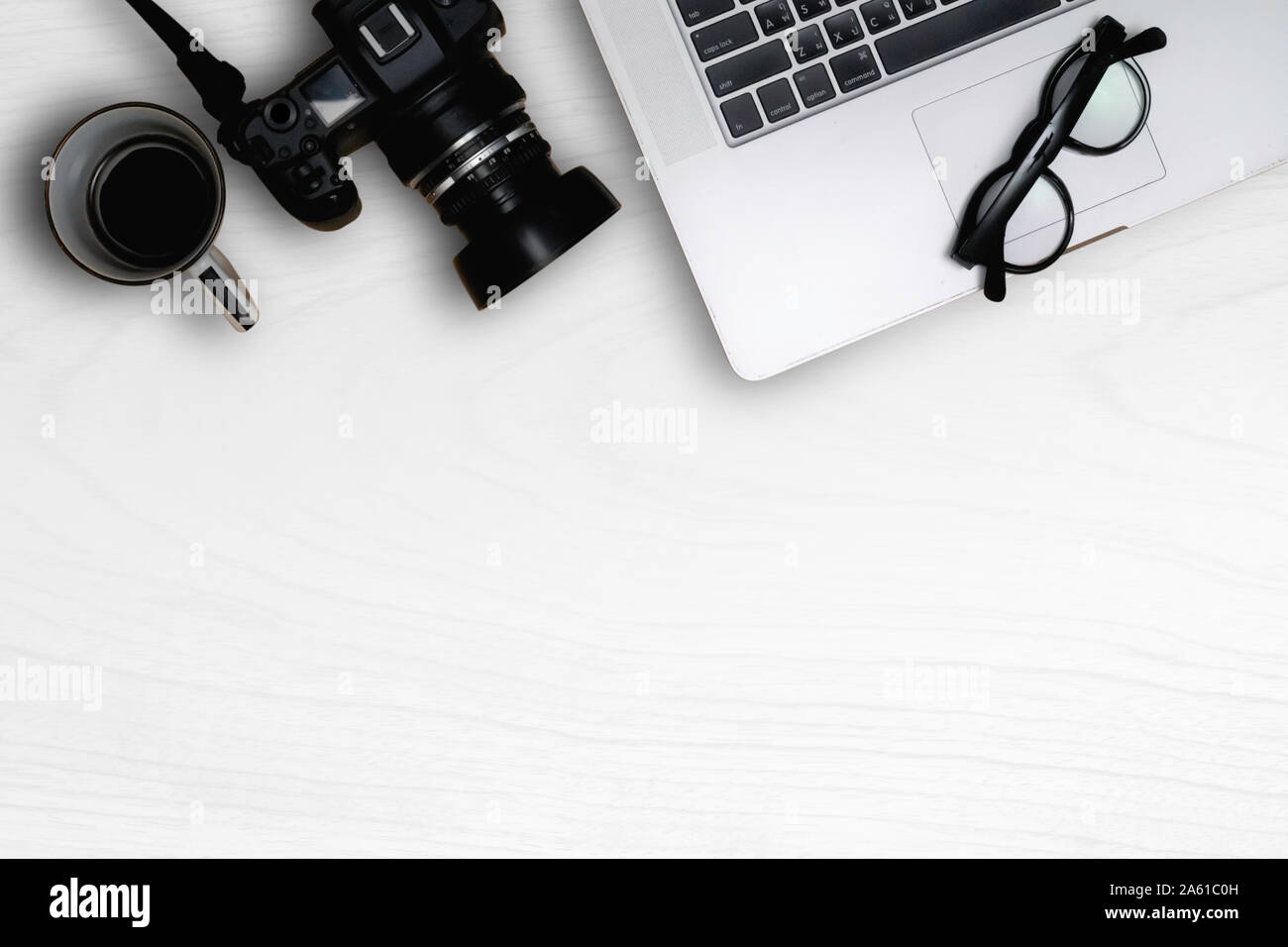 Wood office desk table with laptop, photography device and coffee cup, top view flat layout ...